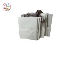 China Custom Eco Friendly Silver Foil Logo Handmade Paper Bags with Ribbon 310x435x280mm for sale
