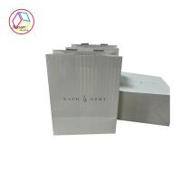 China Custom Eco Friendly Silver Foil Logo Handmade Paper Bags with Ribbon 310x435x280mm for sale