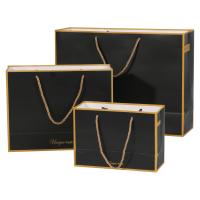 China Bulk Kraft Paper Bags Shopping Embossing Paper Gift Bag With Handles for sale