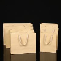 China Bulk Kraft Paper Bags Shopping Embossing Paper Gift Bag With Handles for sale
