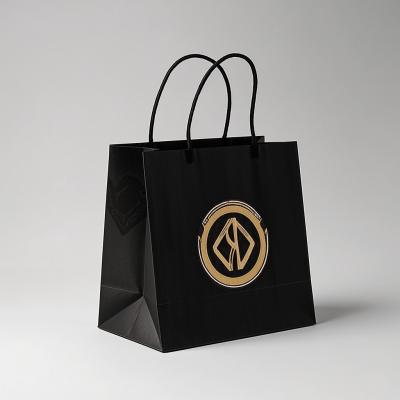 China Custom Printed Eco-Friendly Paper Gift Bags with Cotton Rope Handles for sale