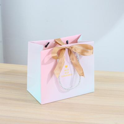 China Recycled Ivory Board Paper Shopping Bags 12x8x4in with Luxury Ribbon Rope for sale