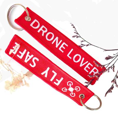 China Custom Red 'DRONE LOVER' Embroidered Keychain – Durable Woven Fabric, Safety Messaging & Bulk Promotional Gift for sale