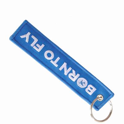China Custom Flight-Themed Keychain - Crisp White Text on Navy Polyester & Durable Metal Ring for Adventurers for sale
