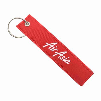 China Double Stitching Custom Embroidered Keychain Metal Loop Design Flight Tag Keyring for sale