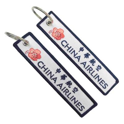 China Dual Side Custom Embroidered Key Tags Airlines Plum Blossom Insignia Bilingual for sale