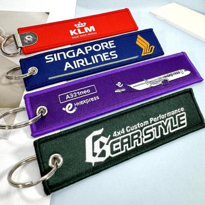 China Custom Double Sided Jet Key Tag Carved Logo Embroidery Keychain Woven Label Fabric Blank Keychains Promotional Jet Carabiners for sale