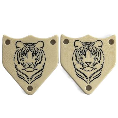 China Irregular Pentagon 3 Hole Fancy Plastic Buttons Engraved Tiger Logo 50L Eco Friendly Resin for sale