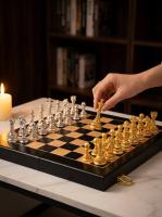 China Hollow Carved Brass Material Mirror Polished Chess Set Luxury Chessboard for Home Decor for sale