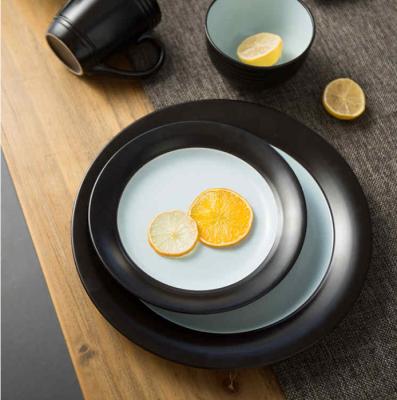 China Reactive Glaze Embossed Dinnerware Set Round Matt Black 12 Piece Ceramic Tableware for sale