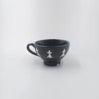 China 9oz Bright Black Glazed White Relief Ceramic Cup Coffee Tea Cup for sale