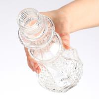 China Glass Small Wine Bottle with Embossed Engraved Mini Liquor Decanter Stopper Lid 50ml 100ml for sale