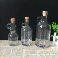 China Sturdy Base 750ml Glass Vodka Whiskey Bottle with Handle and Customization Service for sale