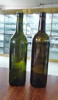 China Empty 750ml Olive Green Round Glass Wine Bottle with Cork Hot Stamping Surface Handling for sale