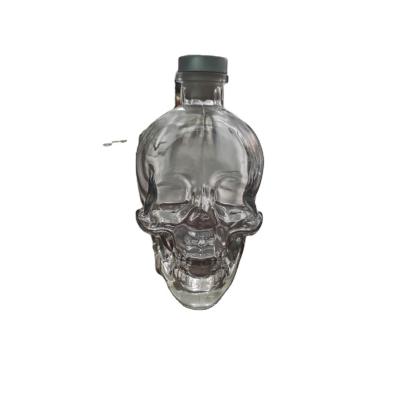 China Hot Stamping Surface Handling Glass Skull Bottle with Stopper 700ml 750ml Transparent for sale