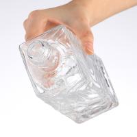 China Embossed Square Wine Glass Bottle With Glass Lid Wine Hot stamping Water wave pattern for sale