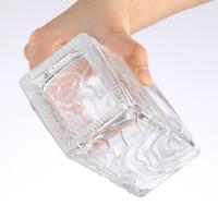 China Embossed Square Wine Glass Bottle With Glass Lid Wine Hot stamping Water wave pattern for sale