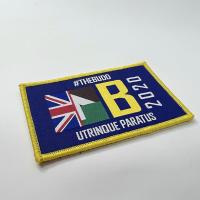China Custom Iron On Woven Patches Merrow Border Sew On Embroidered Badges 100 Pcs MOQ for sale