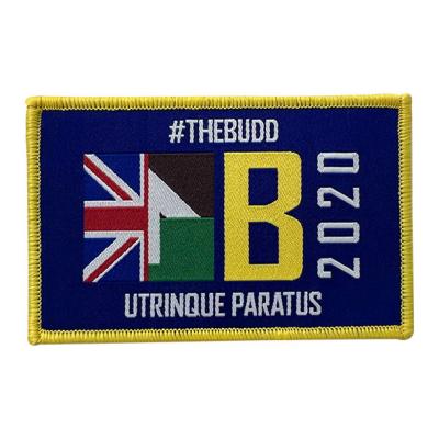 China Custom Iron On Woven Patches Merrow Border Sew On Embroidered Badges 100 Pcs MOQ for sale