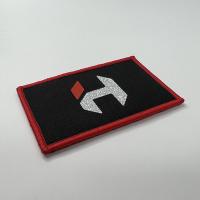 China Red Merrow Border Iron On Embroidery Patch Waterproof Hot Melt Woven Patches for sale