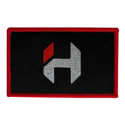 China Red Merrow Border Iron On Embroidery Patch Waterproof Hot Melt Woven Patches for sale