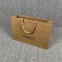 China 200pcs To 500pcs Gold Stamping Clothing Paper Bags Ribbon Handles Kraft Shopping Bags for sale