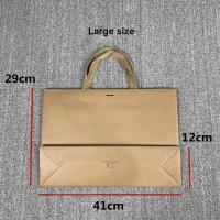 China 200pcs To 500pcs Gold Stamping Clothing Paper Bags Ribbon Handles Kraft Shopping Bags for sale