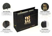 China Grosgrain Handle Matte Black Paper Bag Gold Hot Stamping Retail Paper Shopping Bag for sale
