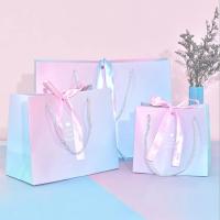 China Custom Logo Holographic Gift Paper Clothing Bags ISO Gradient Drawstring Paper Bag for sale