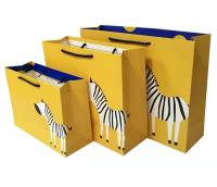 China FSC ISO9001 Yellow Clothing Paper Bags Zebra Print Duplex Board Paper Bag for sale