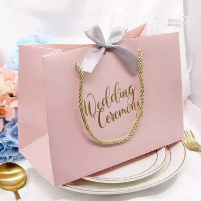 China Offset Printing Patch Handle Kraft Paper Bags Paper Welcome Bags For Wedding Guests for sale