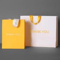 China Silk Rope Handle Peacock Blue Foldable Paper Bag For Clothing Store for sale