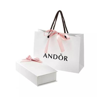 China Tear Resistant 80gsm-120gsm Kids Clothing Paper Bags Custom Logo for sale