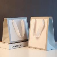 China Foldable Stand Up Ribbon Closure Kraft Paper Bags Paper Bag Packaging For Clothes for sale