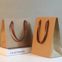 China Foldable Stand Up Ribbon Closure Kraft Paper Bags Paper Bag Packaging For Clothes for sale