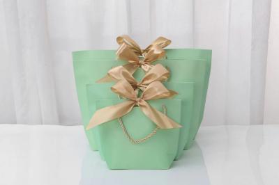 China Stamping Logo Light Green Cosmetic Shopping Bag Bow Tie Ribbon White Gift Bag for sale