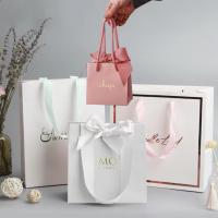 China Apparel Smoky Printed Paper Shopping Bags C2S Artpaper Ribbon Handle Gift Bags for sale