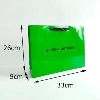 China Gold Logo 26x9x33cm Avocado Green Apparel Paper Bag With Ribbon Handle for sale