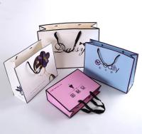 China Cosmetics Three Sections Rope Apparel Paper Bag Ivory Board Boutique Packaging Bags for sale