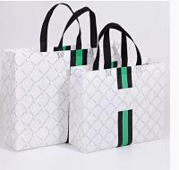 China Logo Printed Gilding Striped Apparel Paper Bag Packaging For Clothes for sale