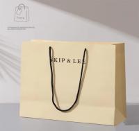 China Grosgrain Handle Matte Black Paper Bag Gold Hot Stamping Retail Paper Shopping Bag for sale
