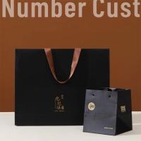 China Grosgrain Handle Matte Black Paper Bag Gold Hot Stamping Retail Paper Shopping Bag for sale