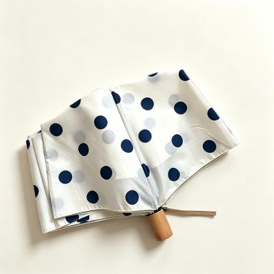 China Lightweight Women's Polka Dot Travel Umbrella with Solid Wood Handle - Portable 3 Fold Parasol for sale