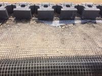 China Fiberglass Geogrid for Strength Roadbed Reinforcement White Asphalt Coated Geogrid for sale