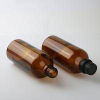 China Clear Amber Glass Essential Oil Bottles 50ml 100ml 200ml With Black Cap for sale