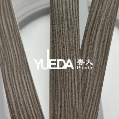 China Dark Brown Wood Grain Plastic Edge Banding Tape 22mm x 0.5mm Moisture Proof Furniture Edging Strip for sale