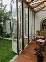 China Custom Cream White French Aluminum Bi-Fold Door For Garden And Patio for sale