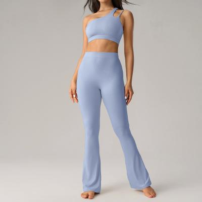 China Cream Women's Asymmetric One Shoulder Sports Bra High Waisted Flared Leggings Set 79% Nylon 21% Spandex for sale