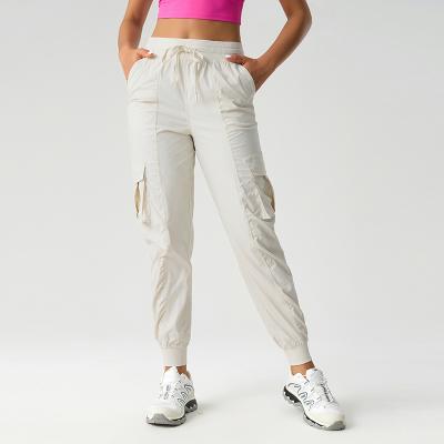 China Women's Beige Nylon Cargo Pants Drawstring Multi Pocket Lightweight Elastic Cuffed for sale