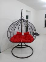 China Modern Outdoor Rattan Wicker Double Seat Hanging Egg Patio Swing Chair with Metal Stand for sale